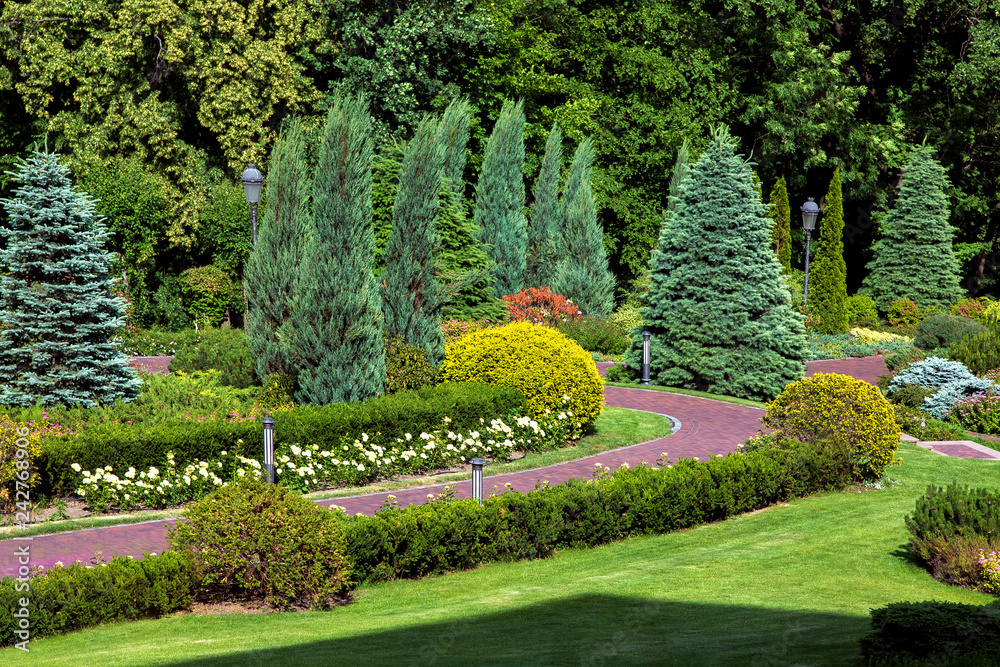 The park with landscape design and walking path for walks, a flower bed ...