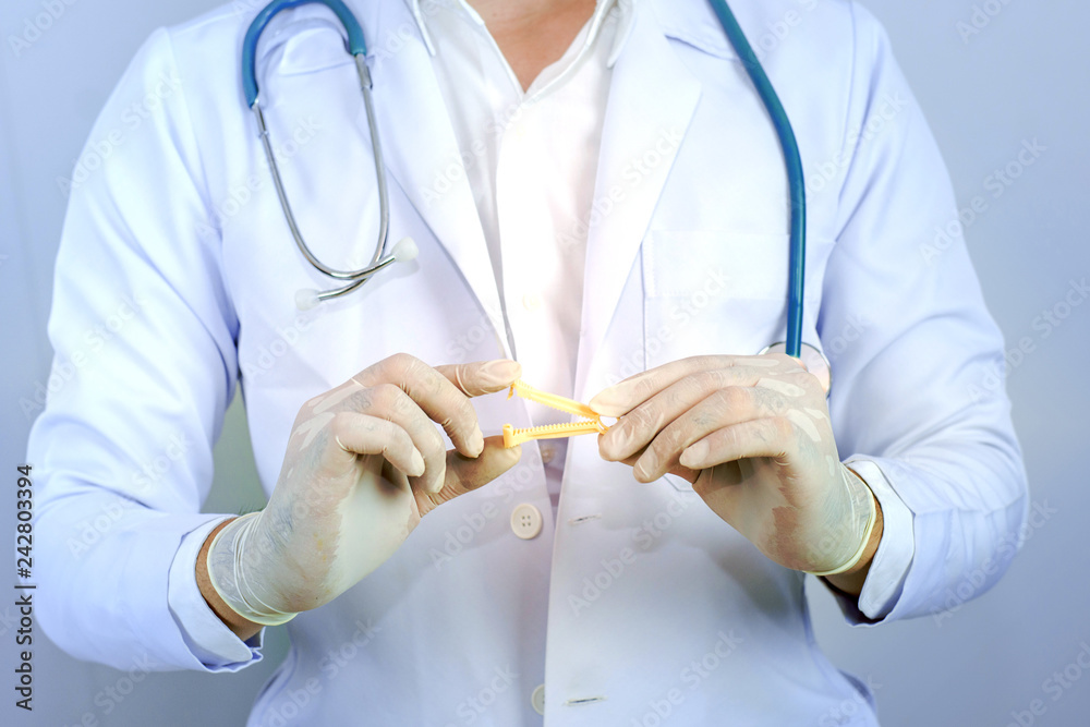 Doctor holding yellow umbilical cord clamp used to clamp off the ...