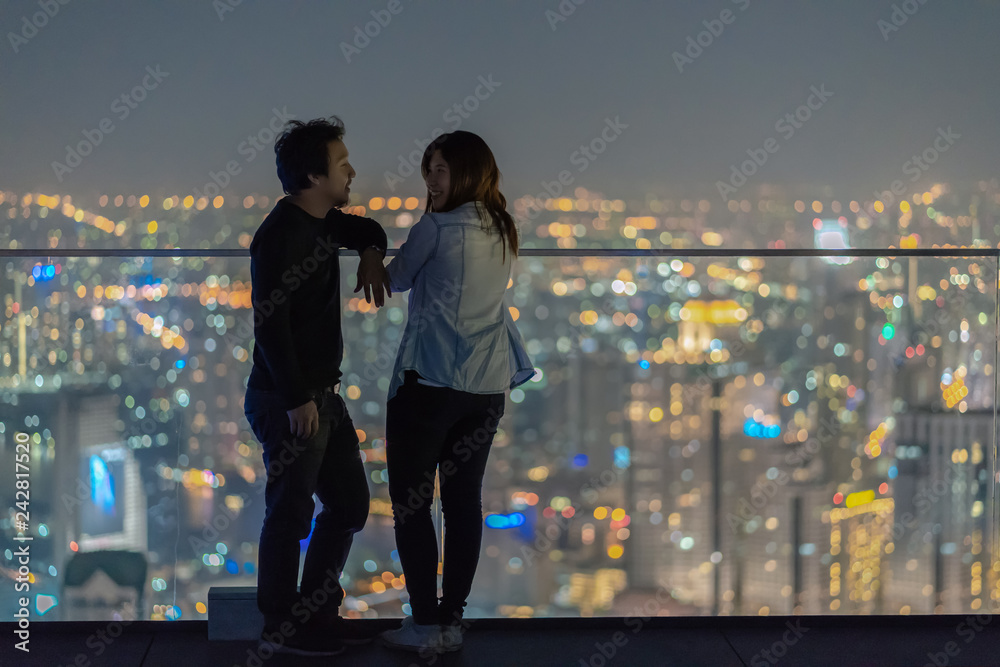 Romantic Couple standing on the rooftop from bangkok modern building at ...