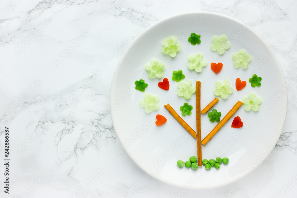 Fun food, vegetables snack plate shaped green tree, springtime and love ...
