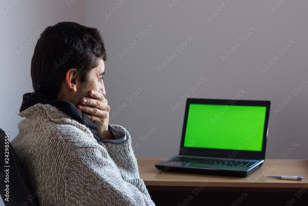 Man looking at green screen laptop with hand covering mouth. Ill person ...