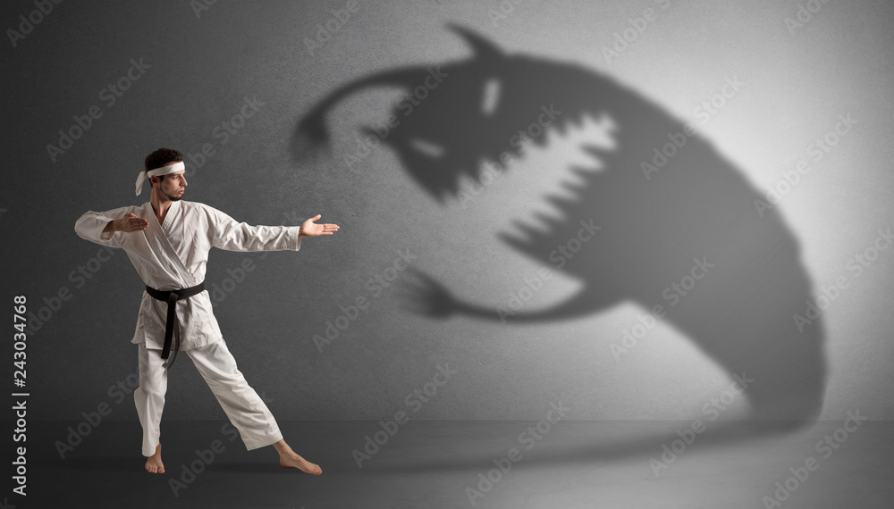 Young karate man fighting with a big black scary shadow Stock Photo ...