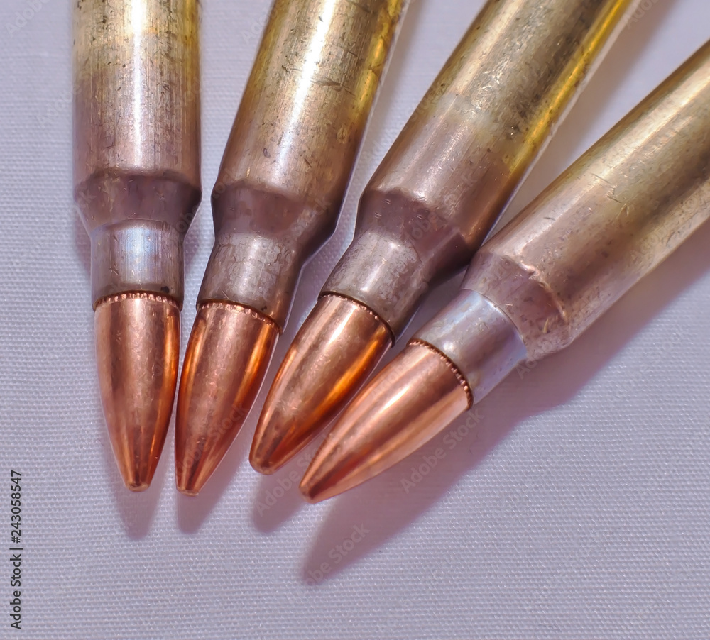 Four .223 caliber rifle bullets on a white background Stock Photo ...