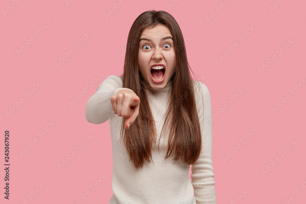 Irritated Caucasian woman points with anger at camera, exclaims with ...