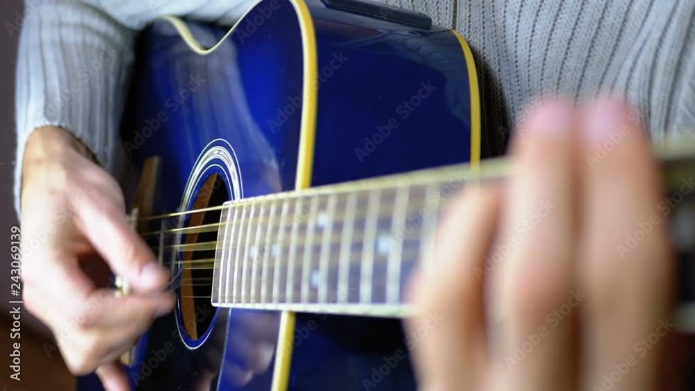 Man Playing an Acoustic Guitar. Slow movement of the vibrating string ...