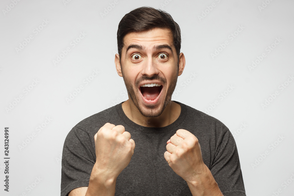 Soccer fan concept. Young attractive man shouting while his team win ...