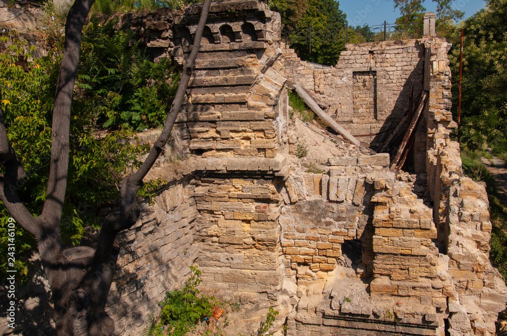 Old ancient destroyed stone house on the yard with trees around ...