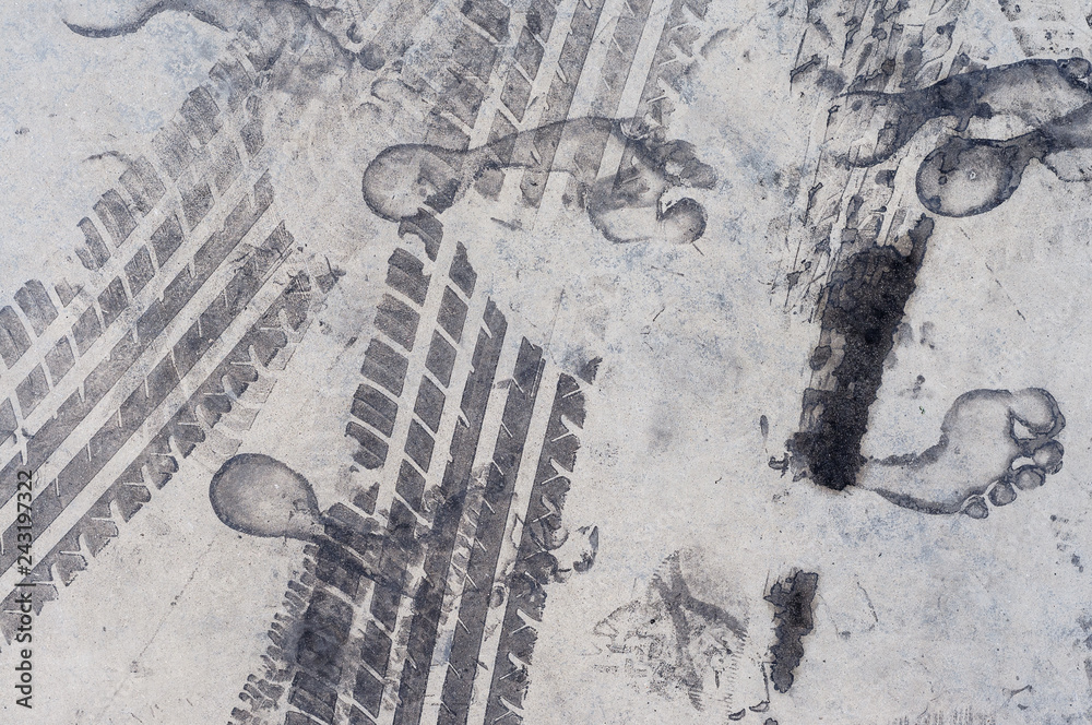 Road tire and the human footprint on the road. Background texture ...