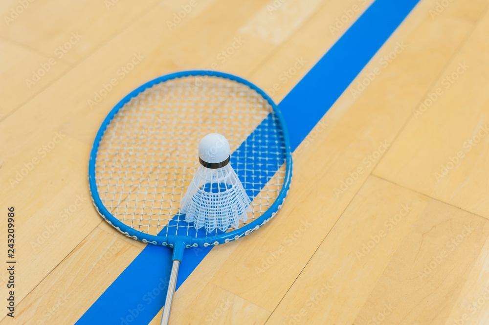White badminton shuttlecock on a hall floor at badminton courts .Close ...