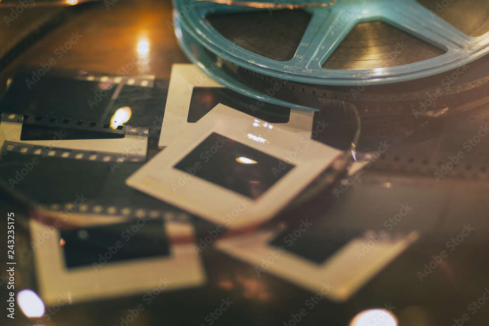 Photo slides, film negatives and 8mm or super 8 vintage film reel on a ...