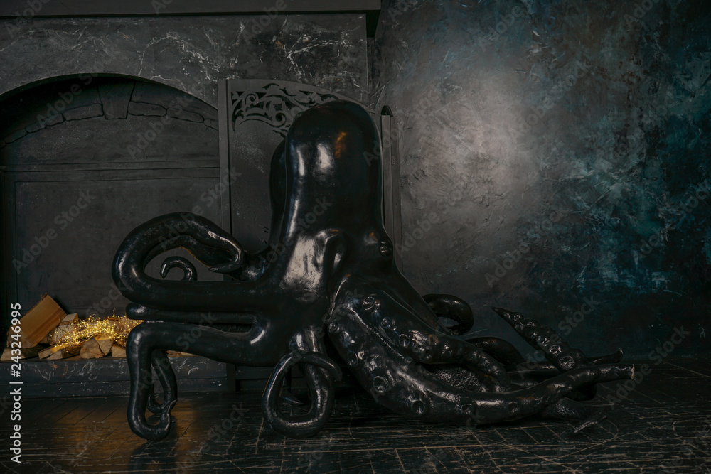 scary octopus chair on the background of a black large fireplace with ...