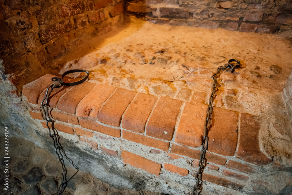 prison shackles on the brick wall Stock Photo | Adobe Stock