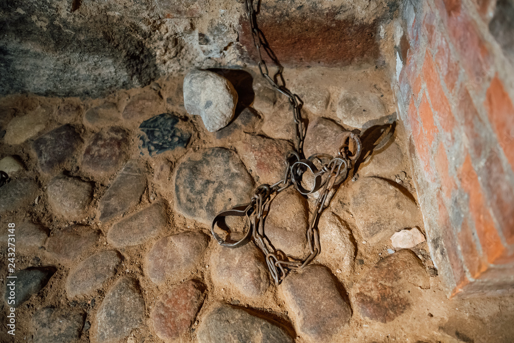 prison shackles on the brick wall Stock Photo | Adobe Stock