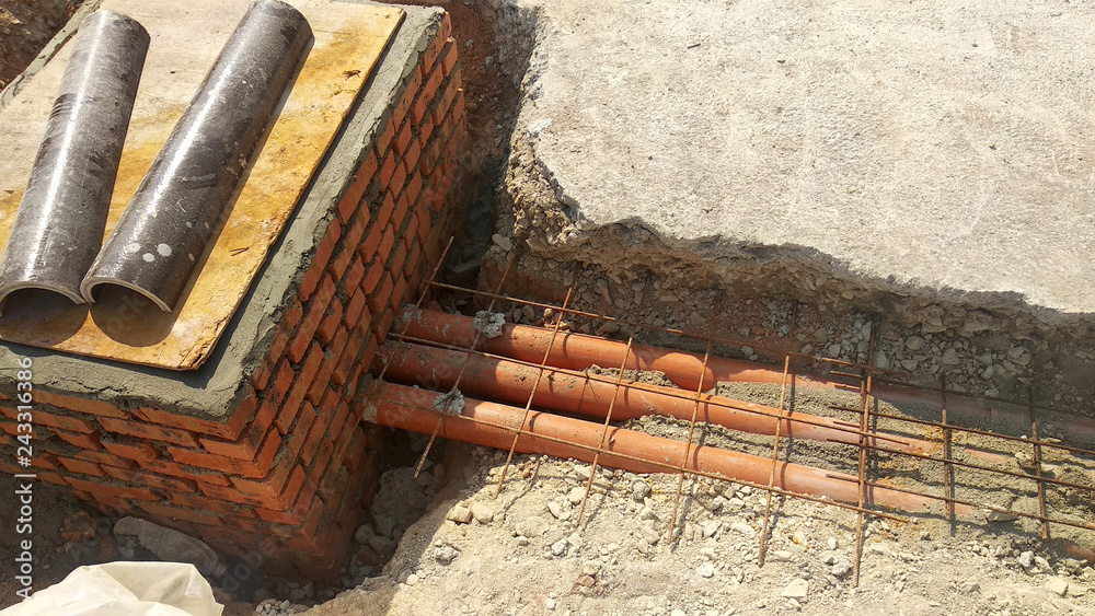 Underground utility and services pipe laid by workers in the trenches ...