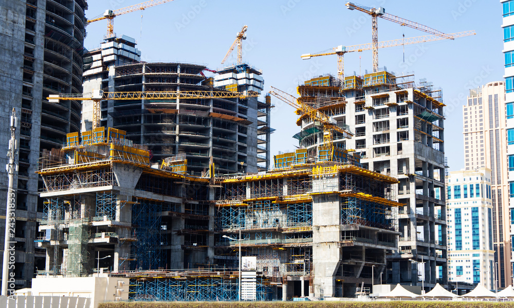 Four modern multistory buildings under construction. Big construction ...