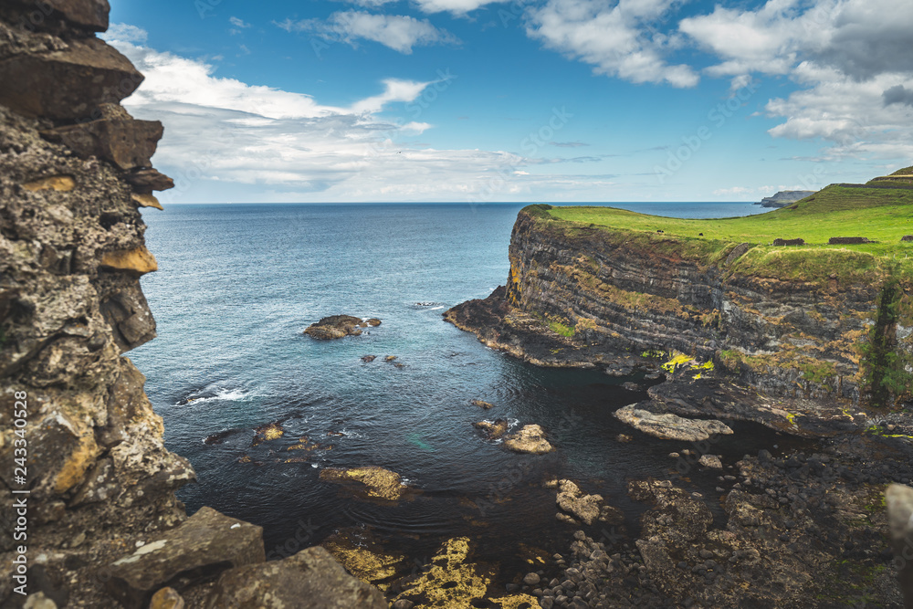 Irish bay surrounded by the green covered rocks. Northern Ireland ...