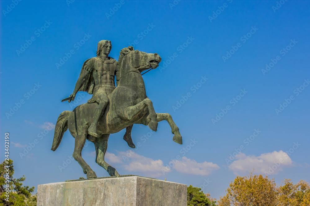 Alexander the Great sculpture on blue sky background above top of trees ...