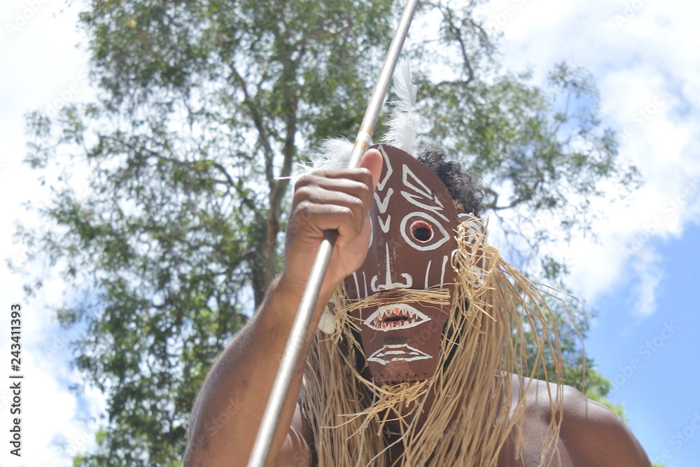 Unrecognizable Torres Strait Islander man dancing traditional dance in ...