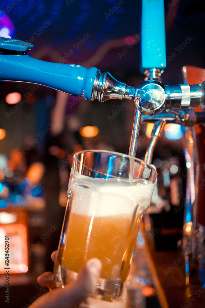 Bartender pouring from tap fresh beer into the glass in pub Stock Photo ...