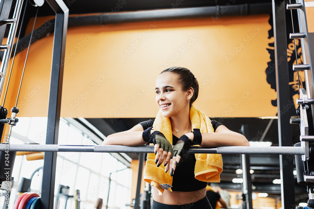 Smiling young girl champion in the barbell smiles after a grueling ...