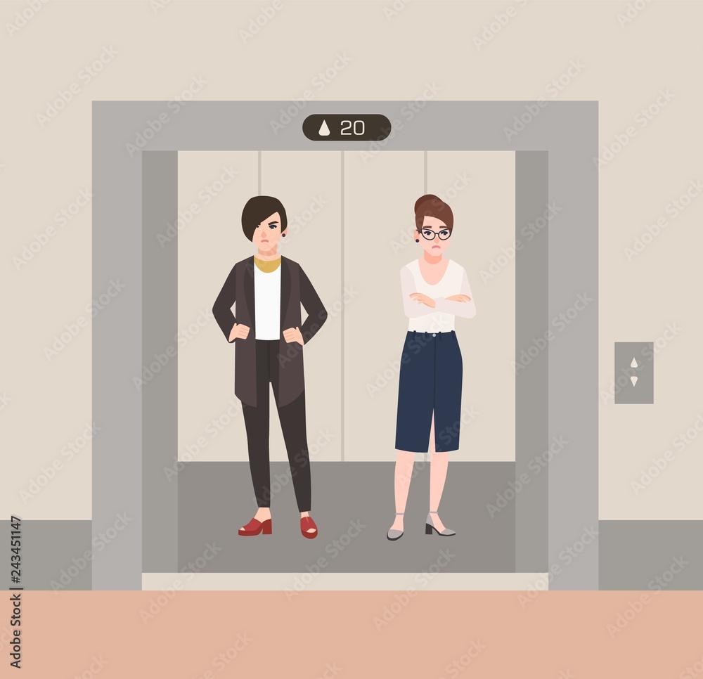 Pair of angry young women standing in elevator with open doors. Grumpy ...