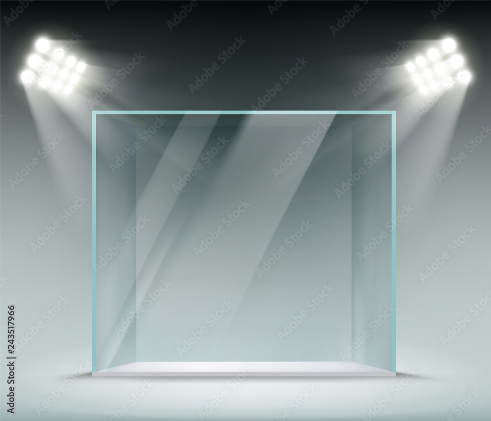 Glass transparent cube illuminated by spotlights. Showcase for the sale ...