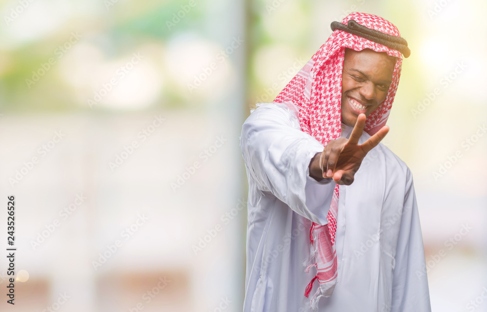 Young arabic african man wearing traditional keffiyeh over isolated ...