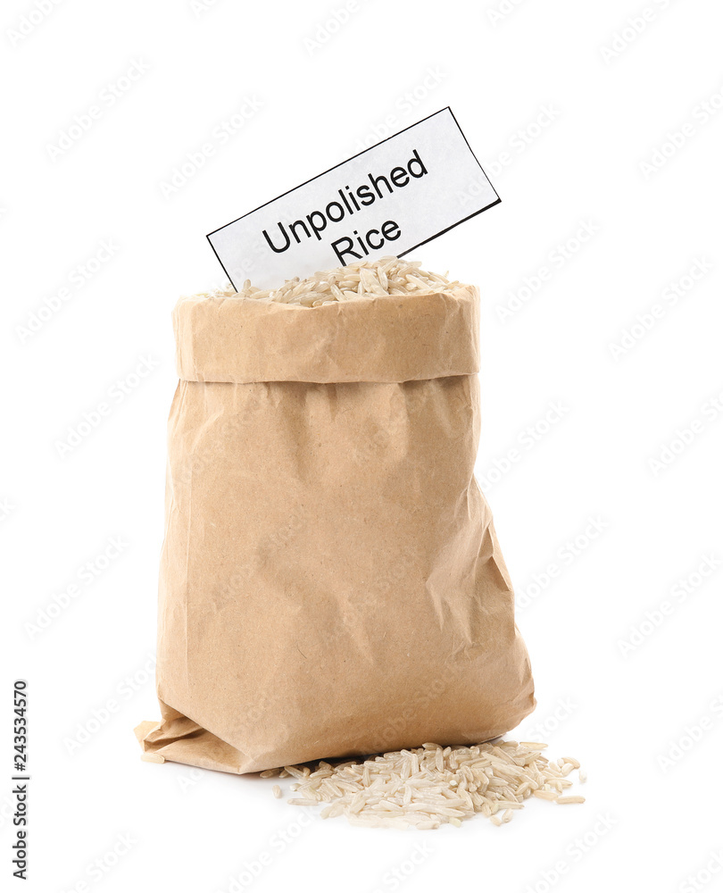 Paper bag with raw unpolished rice and card on white background Stock ...