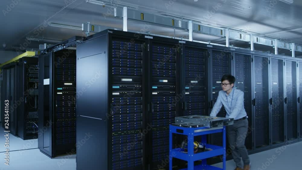 In the Modern Data Center: IT Technician Working with Server Racks ...