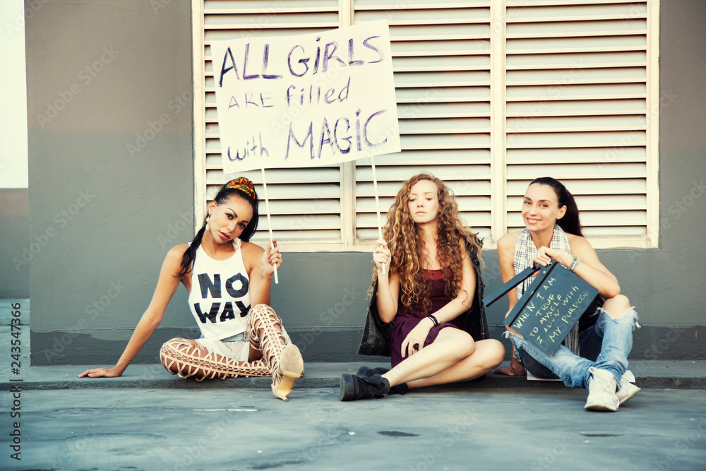 The girls are sitting on the street with a poster. International Womens ...