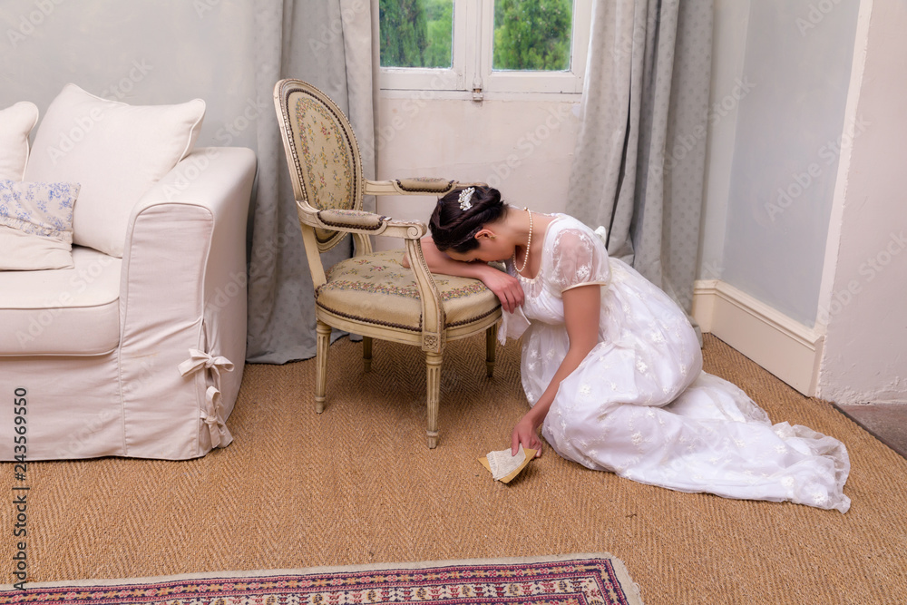 Sad lady in antique dress Stock Photo | Adobe Stock
