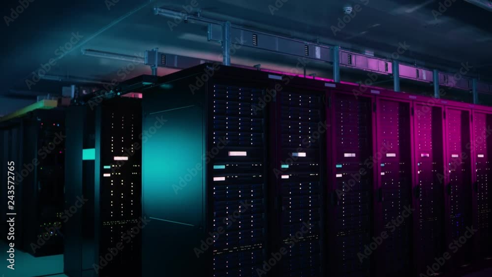 Descending Shot of Data Center With Multiple Rows of Fully Operational ...