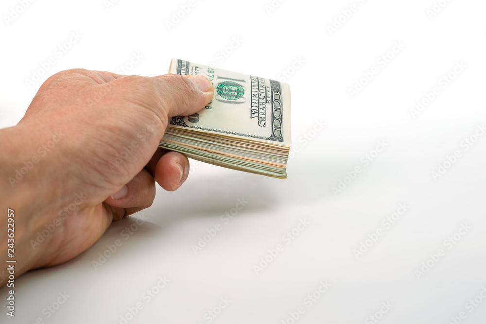 US dollar bill. Man hand holding stack of banknotes in half fold ...