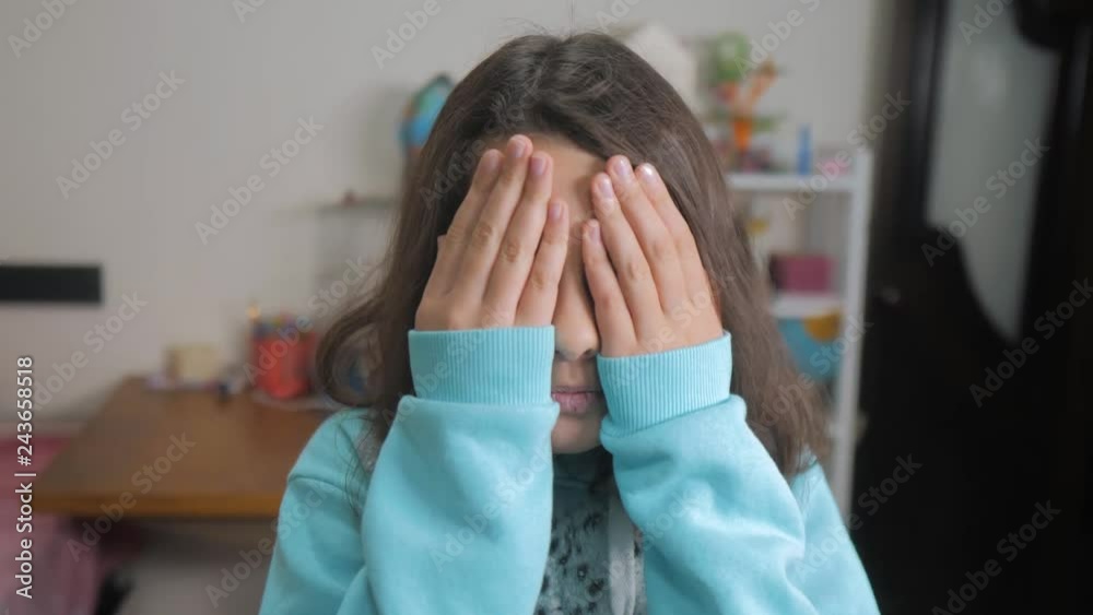 Stockvideon peek a boo. little girl covered her eyes face with her hands hide-and-seek waiting ...