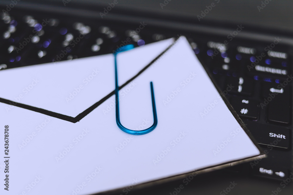 laptop keyboard with envelope and clip symbol of email attachments ...