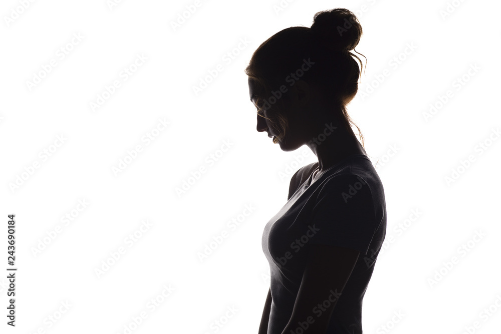 profile silhouette of a pensive girl, a young woman lowered her head ...
