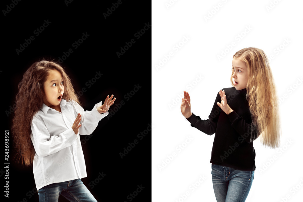 The portrait of two frightened, afraid, scared girls on a white and ...