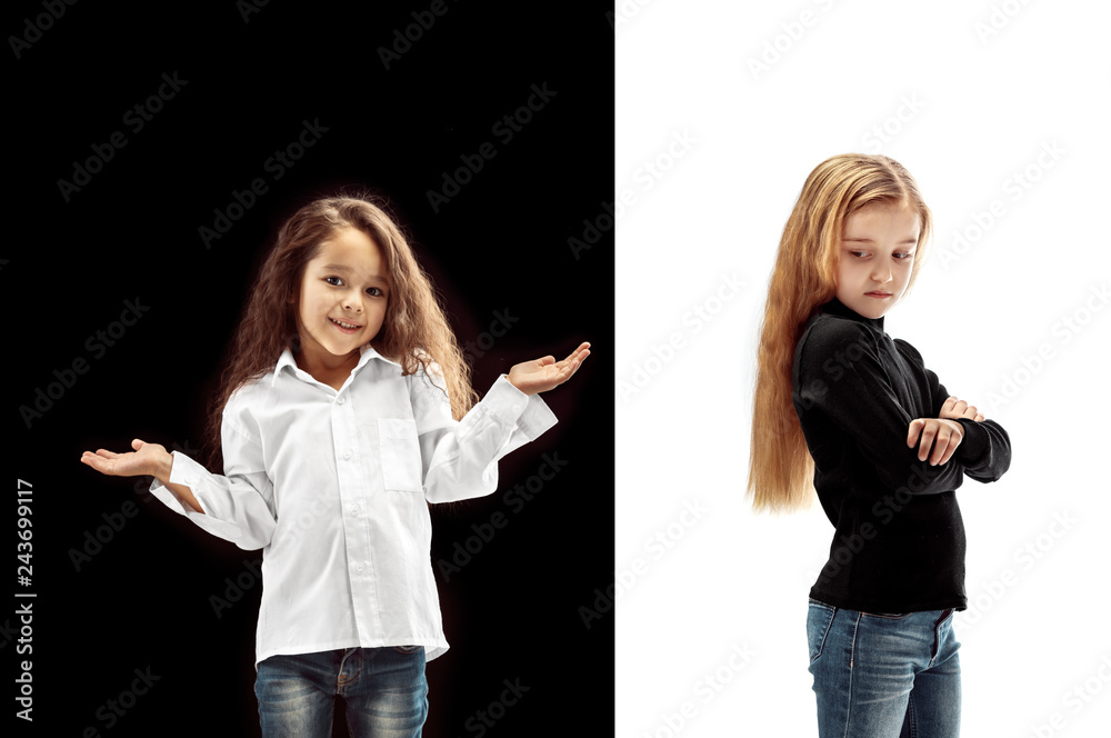 The portrait of two emotional happy surprised girl and serious girl on ...