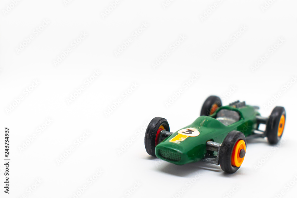 Miniature green race car with number 3 isolated on a white background ...
