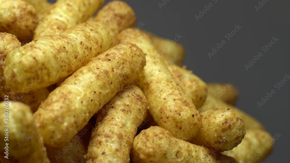 Corn puffs. Rotation. Close up. Puffcorn with peanut flavor. Corn ...