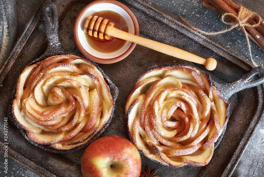 Homemade puff pastry with rose shaped apple slices baked in iron ...