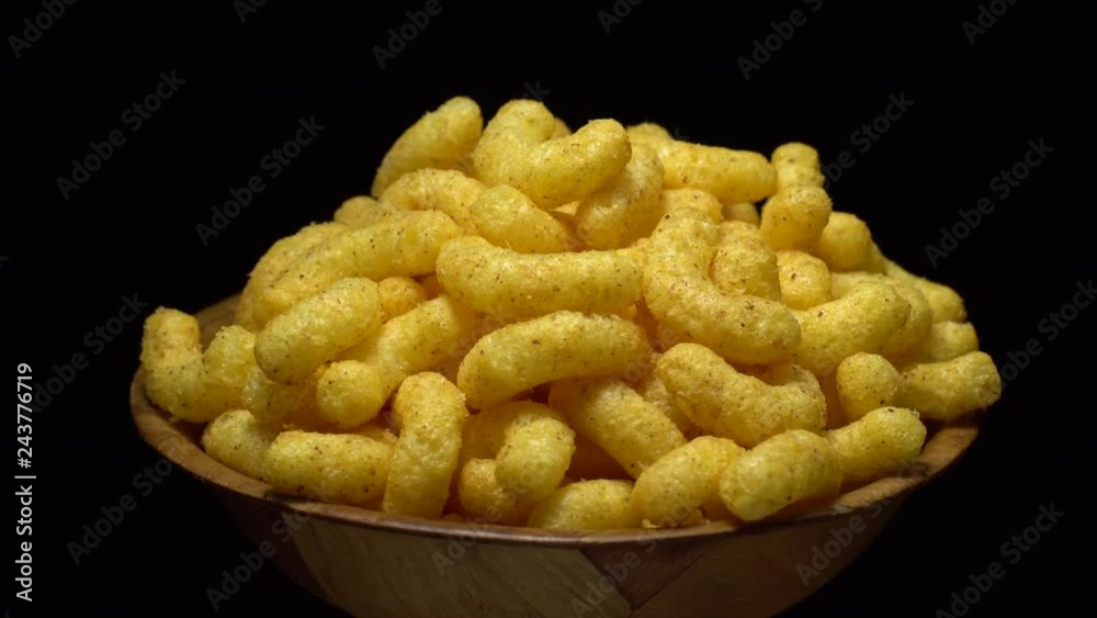 Corn puffs. Rotation. Close up. Puffcorn with peanut flavor. Corn ...