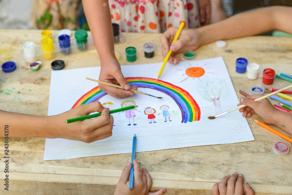 Happy family concept. Co-creation. Children hands draw on a sheet of ...