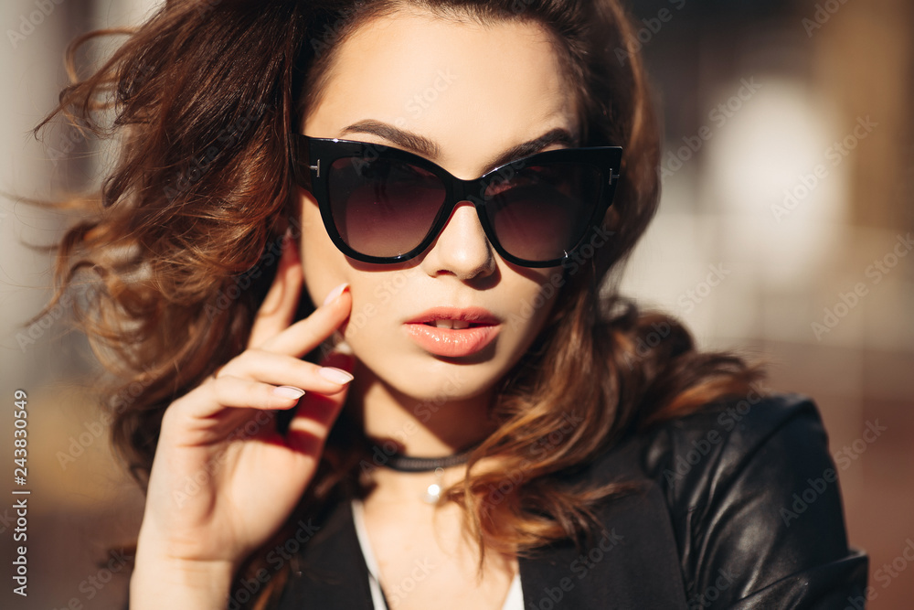 Gorgeous brunette woman with plump lips, sensuality touching face skin ...