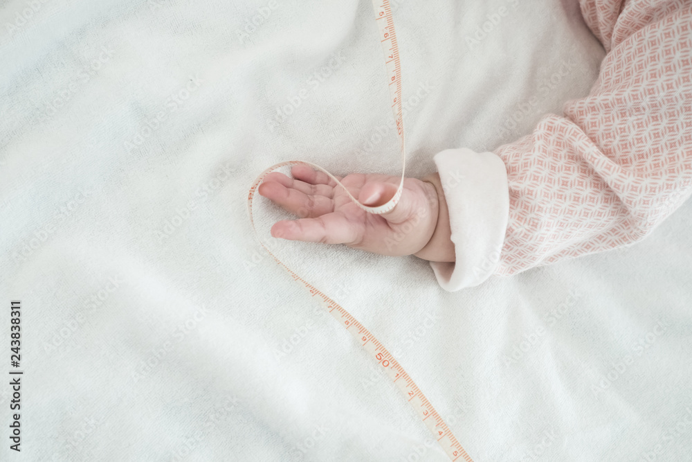 Baby hand and measuring tape: concept of baby growth, height ...