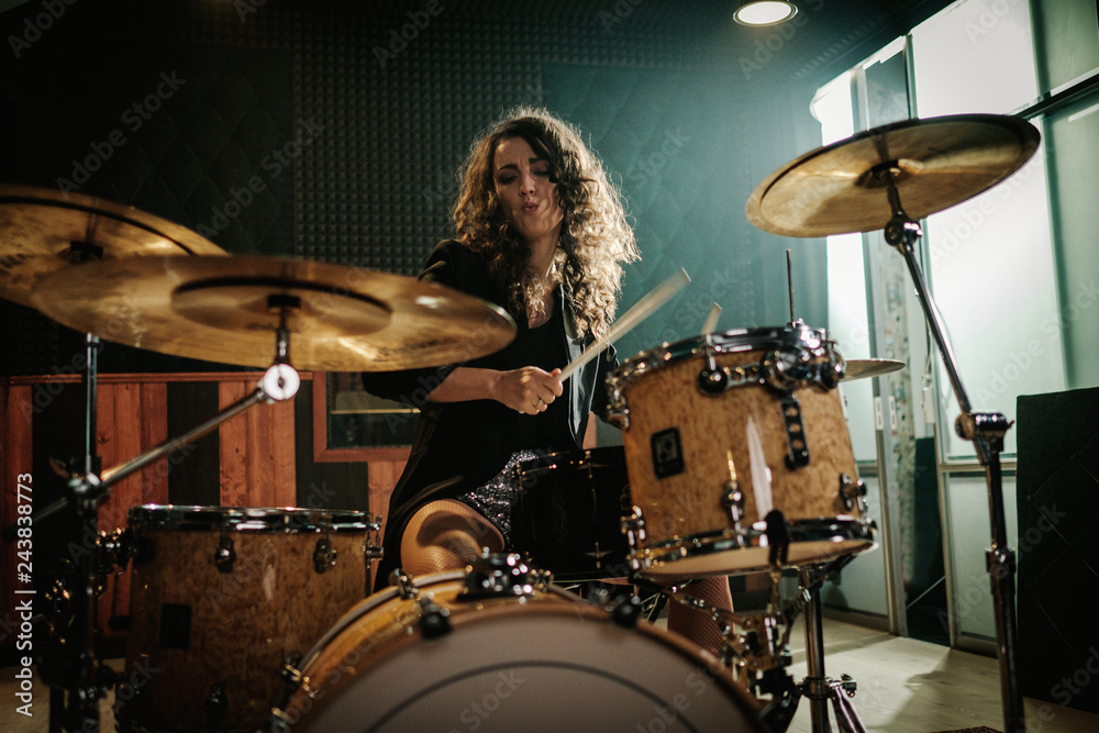 Woman playing drums during music band rehearsal Stock Photo | Adobe Stock