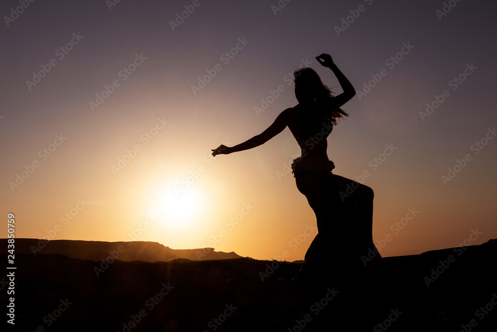 Silhouette of Woman dancing to the famous belly dance with sunset in ...