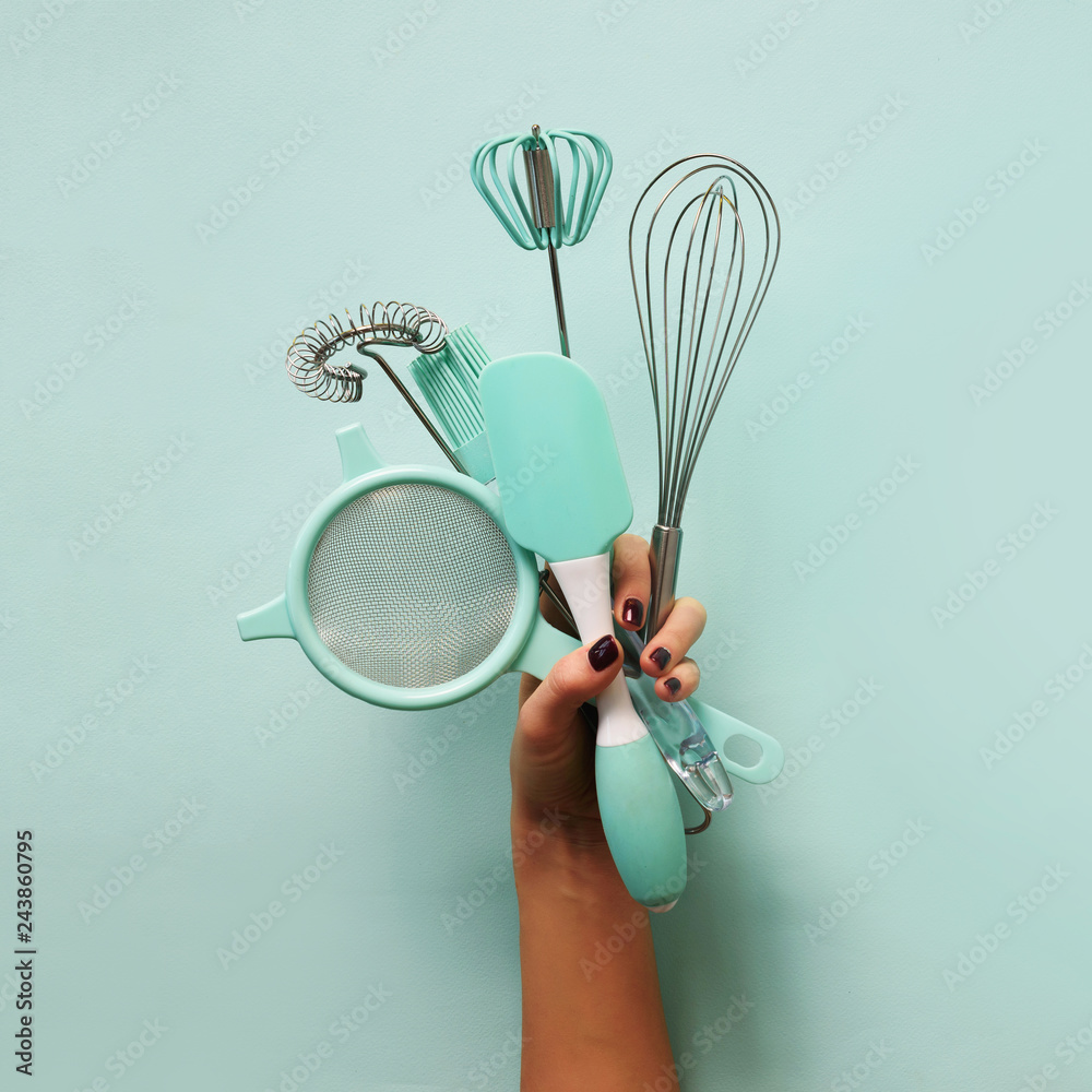 Baking flat lay. Female hands holding kitchen tools, sieve, rolling pin ...