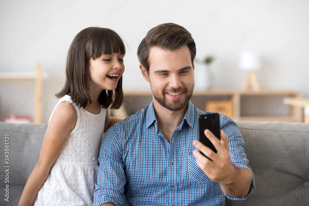 Happy dad laughing taking selfie with kid daughter on smartphone at ...