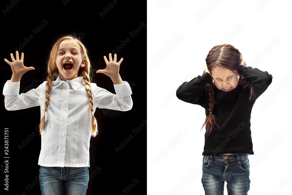 The portrait of two happy screaming girls on a white and black studio ...